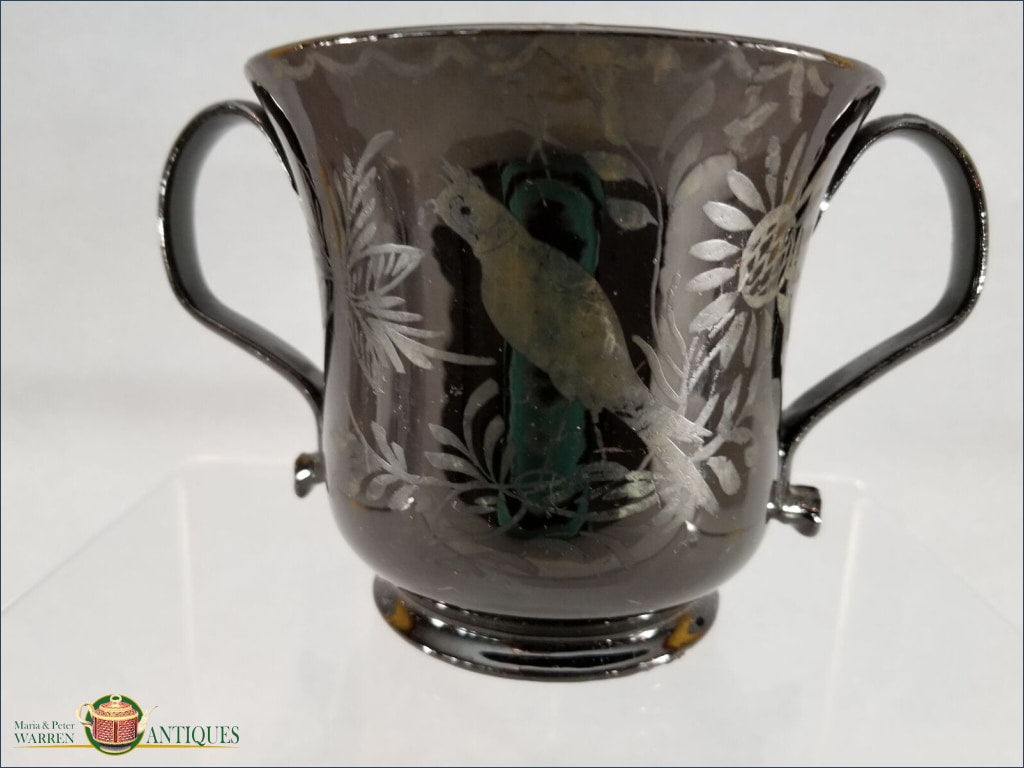 An Antique English Jackfield Loving Cup decorated with a bird and flow ...